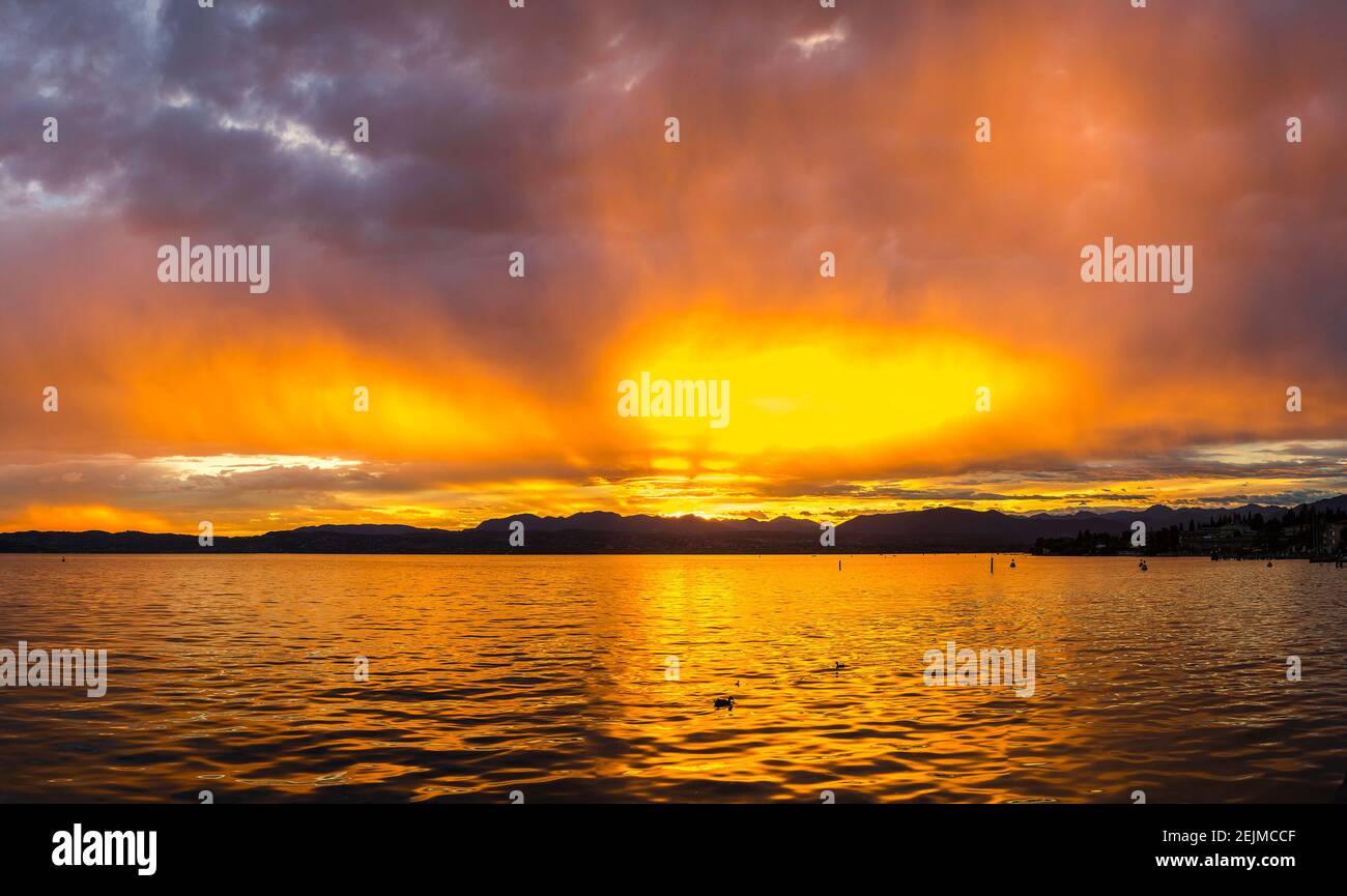 Panorama of Sunset on Garda lake in Italy in a beautiful summer evening ...