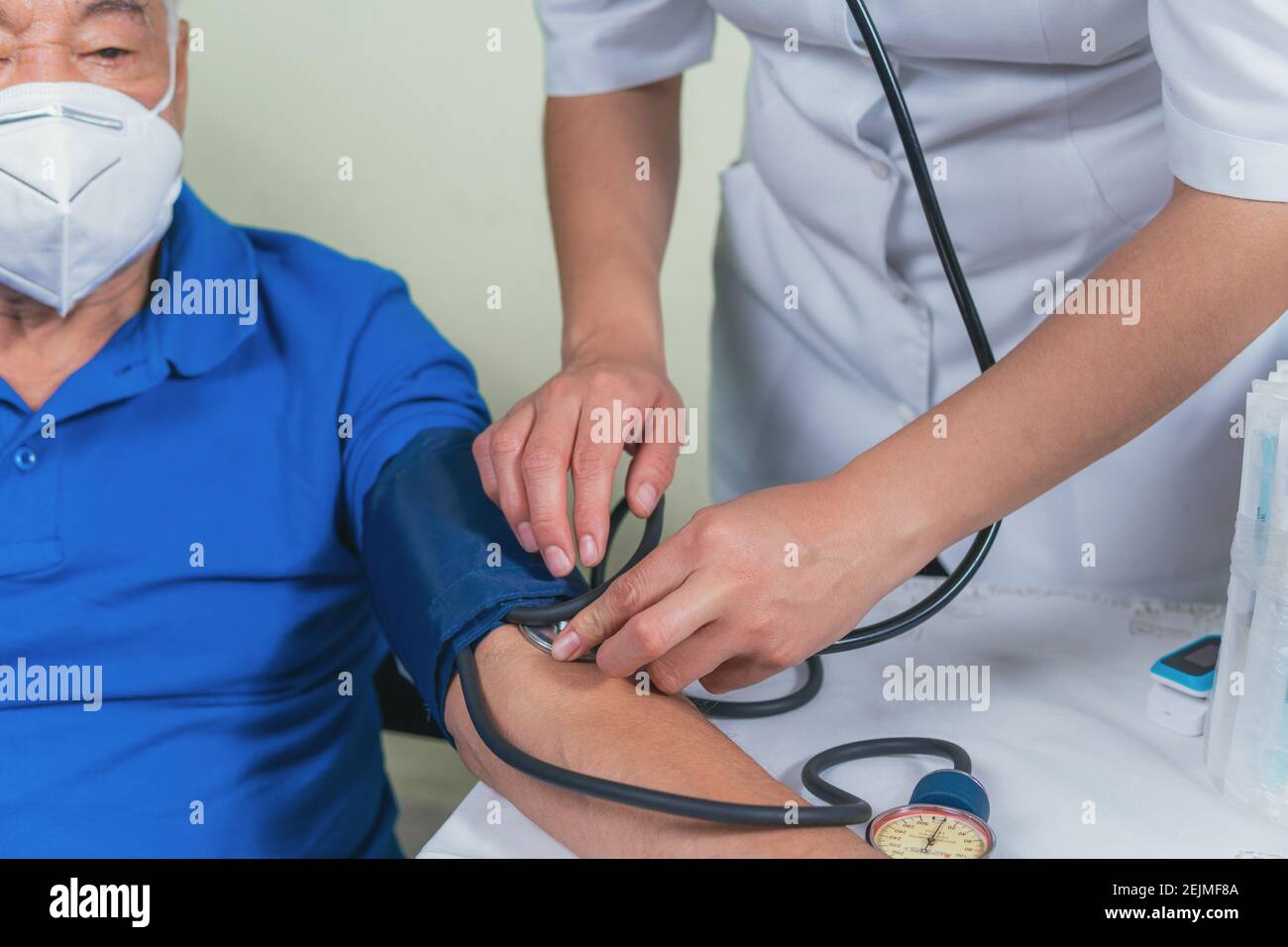 shows how to measure blood pressure in an older man Stock Photo - Alamy