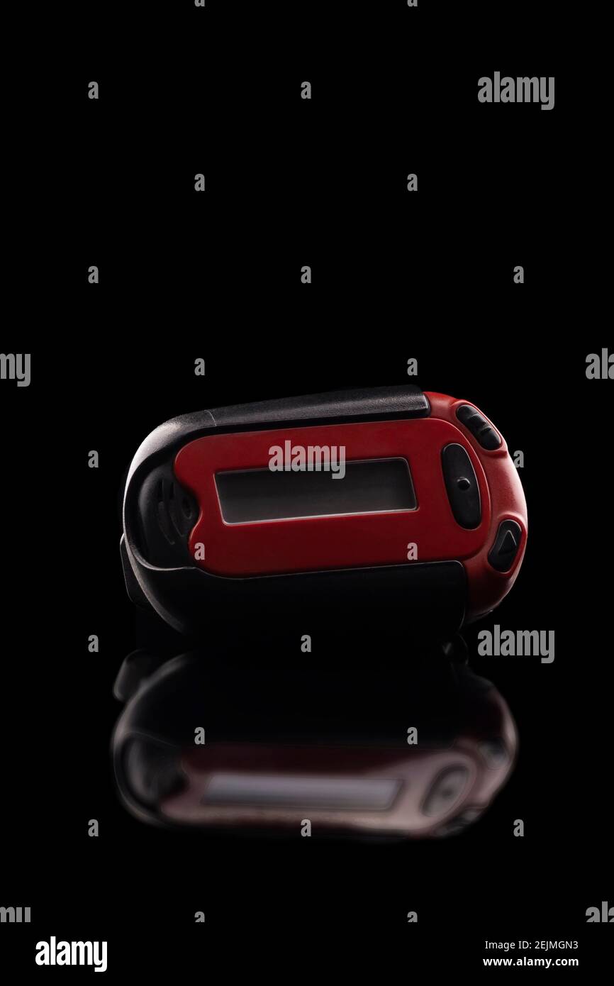 Retro red pager captured isolated on black background and reflective ...