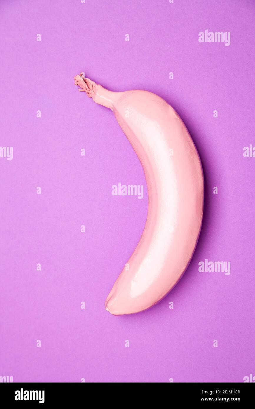 Shiny pink banana placed on purple surface Stock Photo - Alamy
