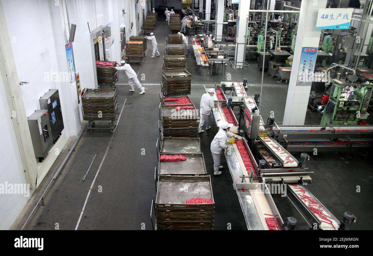 Staff of a food processing factory owned by Shuanghui Group, a China ...