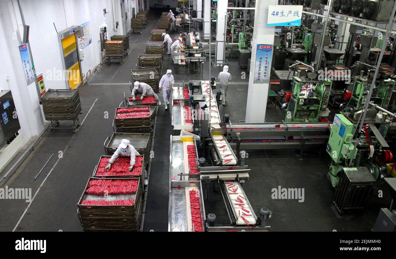 Staff of a food processing factory owned by Shuanghui Group, a China ...