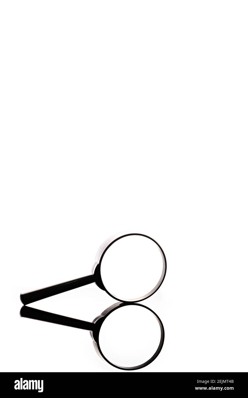Close up of a magnifying glass device shot isolated against perfect ...
