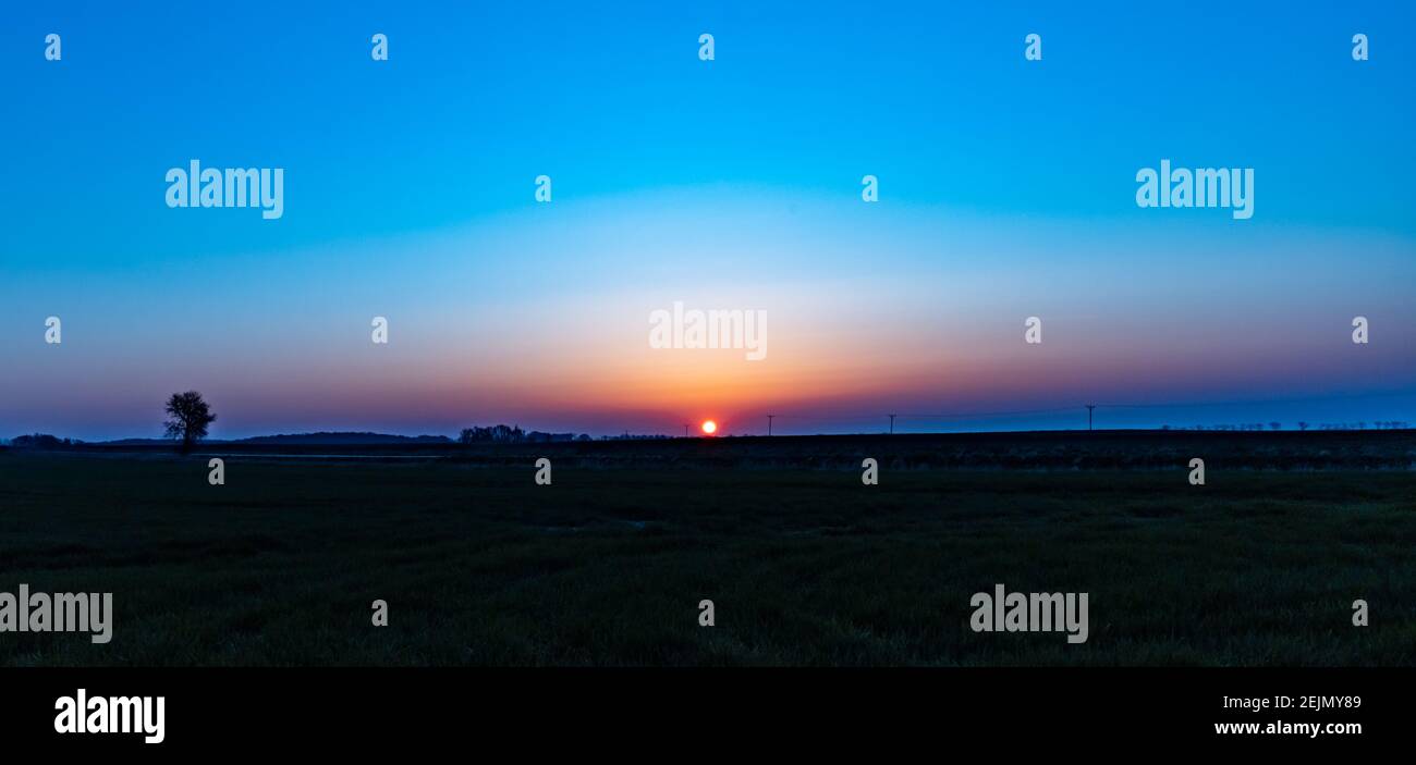 Beautiful sunrise at morning over huge green fields Stock Photo - Alamy
