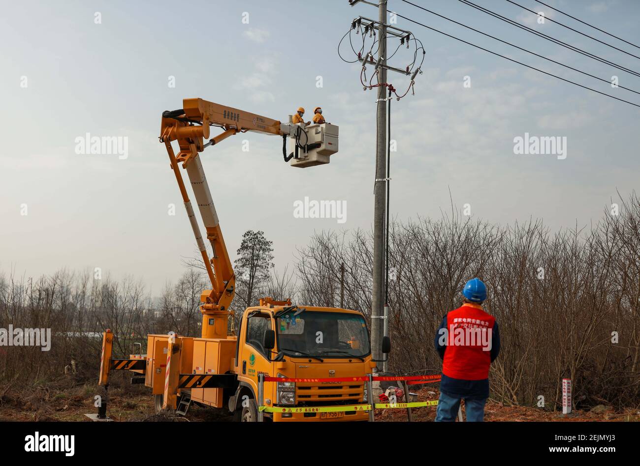 Chinese electricians perform live working on electric transmission ...