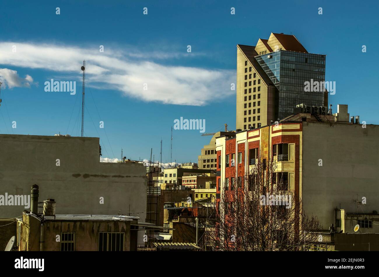 View of the roofs of densely built-up Tehran with a view of a high-rise ...
