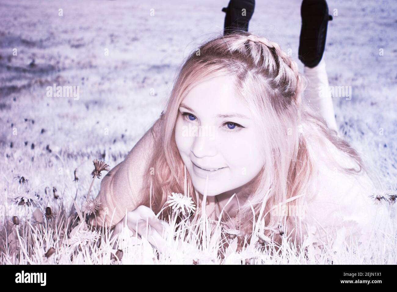 Infrared Portrait of a Hippie Girl lying in a Flower Meadow on a sunny ...