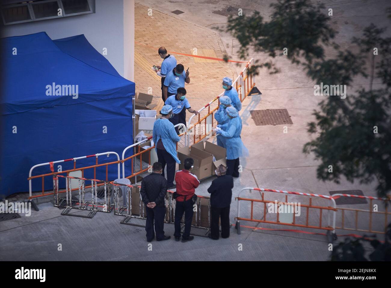 Medical professionals wear protective gear at a Chun Yeung Estate, a ...