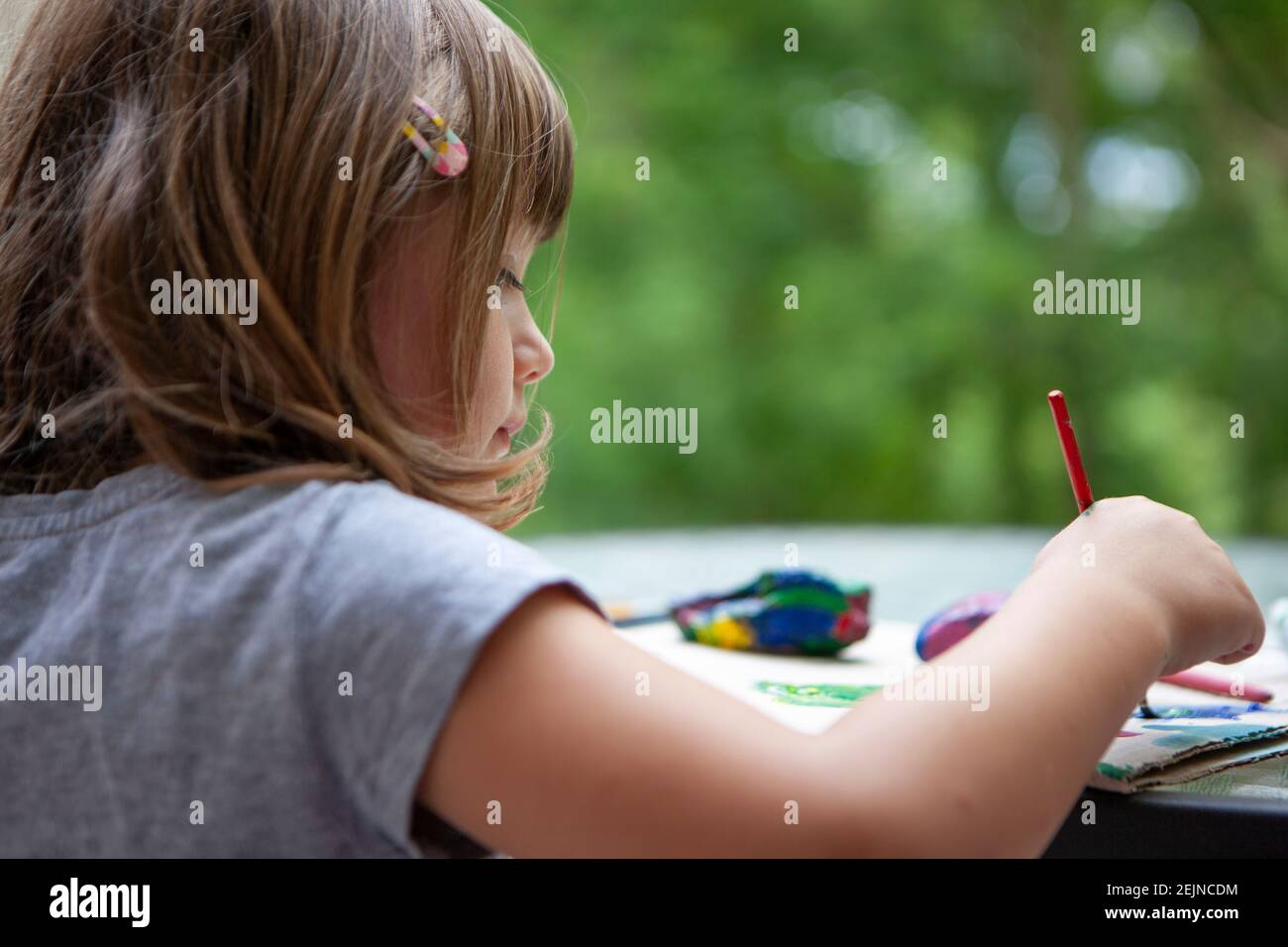Creative Girl paints Rocks outside Stock Photo - Alamy