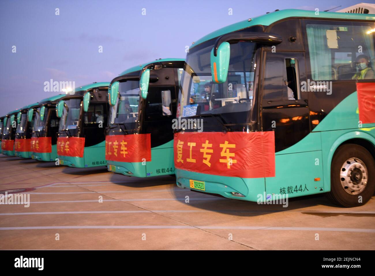 Shuttle buses park at the Sanya Phoenix International Airport to pick ...
