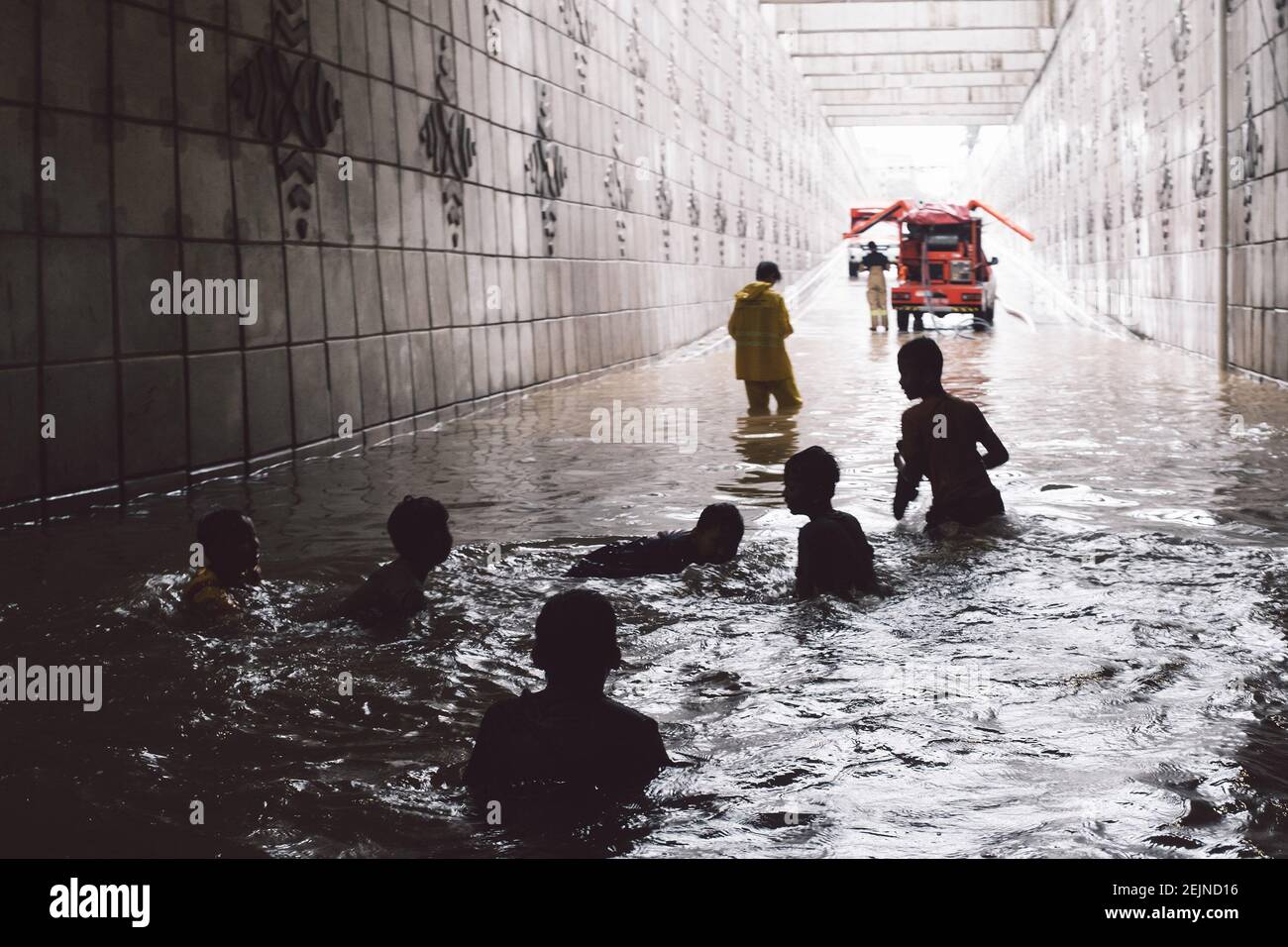 Children playing during a flood on a road in Jakarta on February 25 ...
