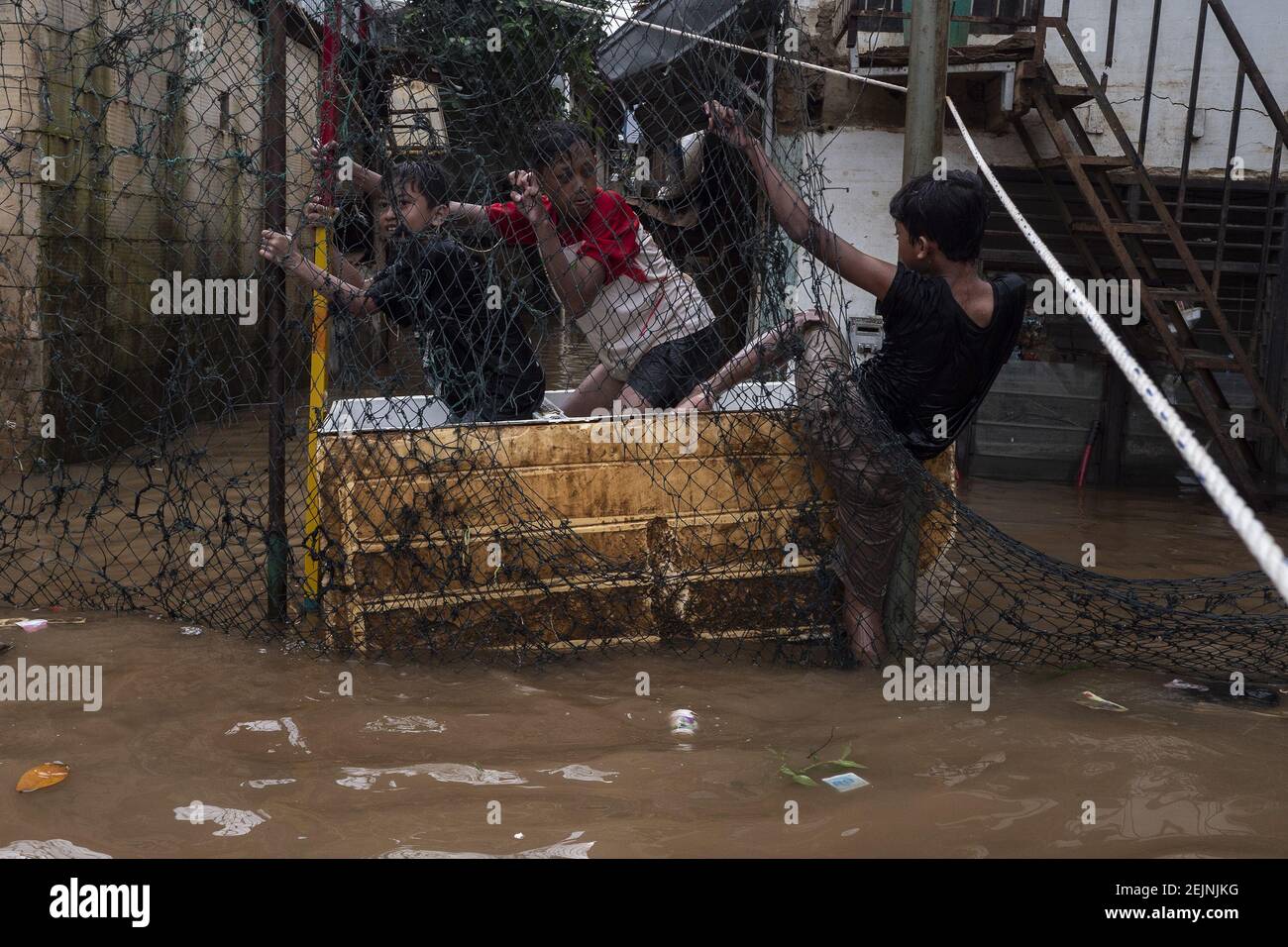 Kids playing in the flooded water. Heavy rains triggered widespread ...