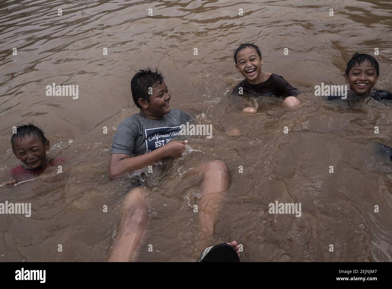 Kids playing in the flooded water. Heavy rains triggered widespread ...