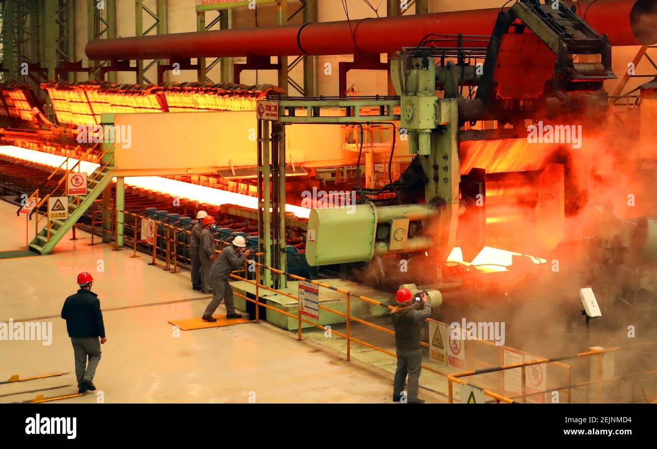 The workers are observing the steel in the steelmaking workshop. (Photo ...