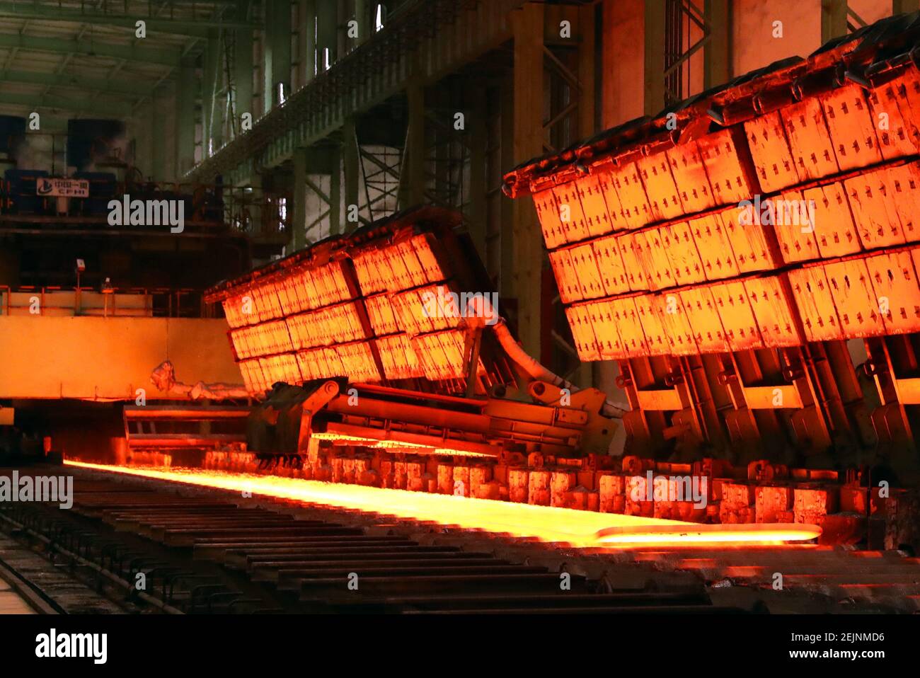 The workers are observing the steel in the steelmaking workshop. (Photo ...