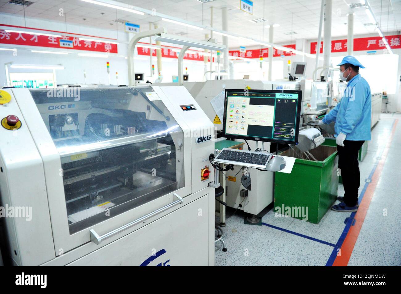 A Chinese worker manufactures integrated circuit boards at the plant of ...