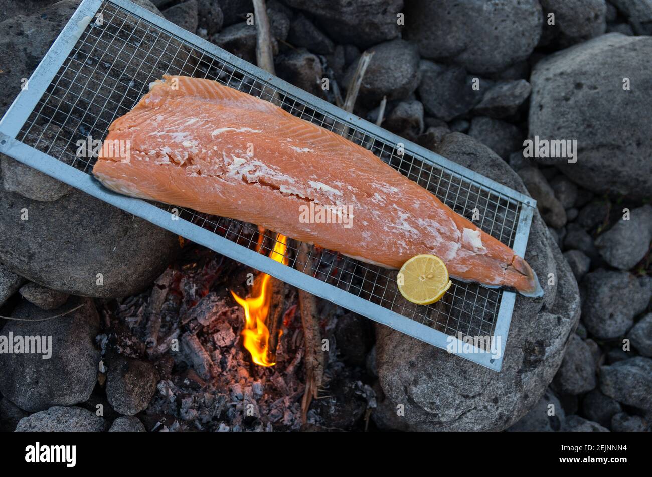Closeup shot of fish roasting on a fire near the Sea of Galilee in ...