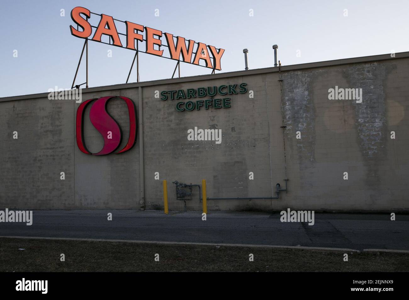 A logo sign outside of a Safeway retail grocery store location in ...