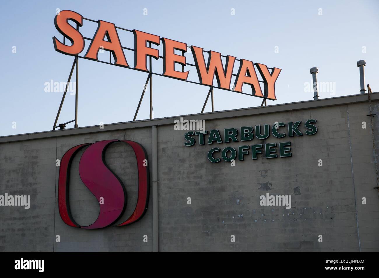 A logo sign outside of a Safeway retail grocery store location in ...