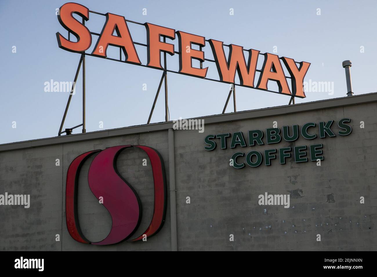 A logo sign outside of a Safeway retail grocery store location in ...