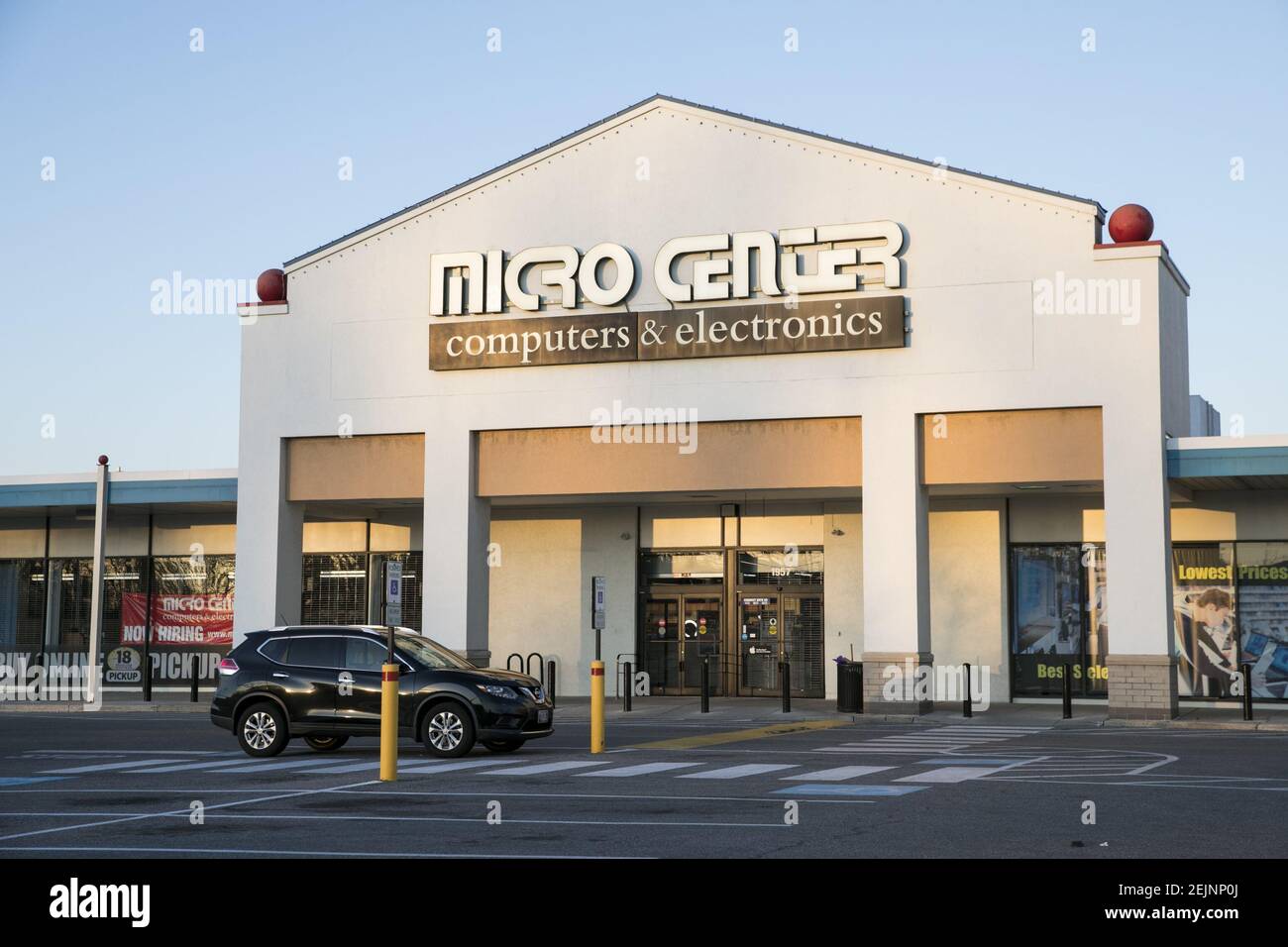 A logo sign outside of a Micro Center retail store location in ...