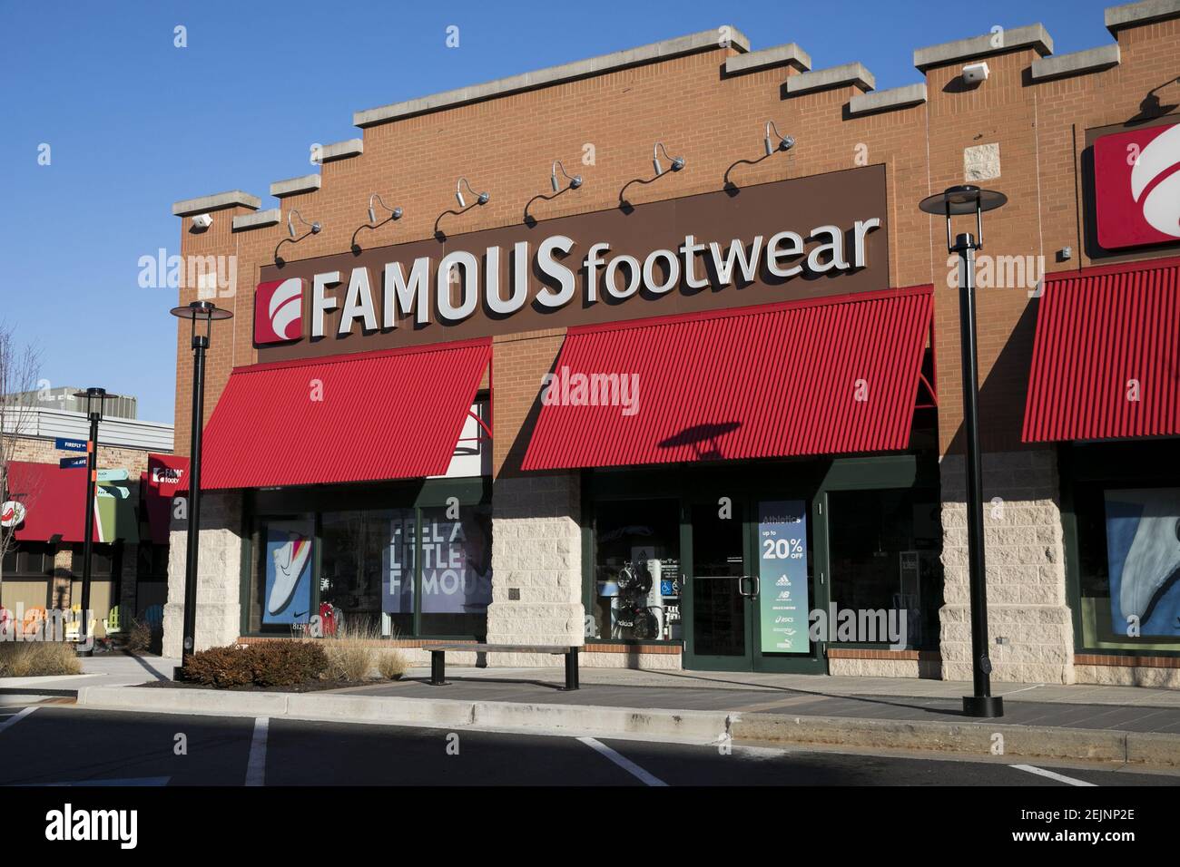 A logo sign outside of Famous Footwear retail store location in ...
