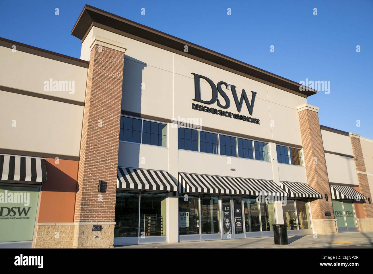 A logo sign outside of a Designer Shoe Warehouse (DSW) retail store ...