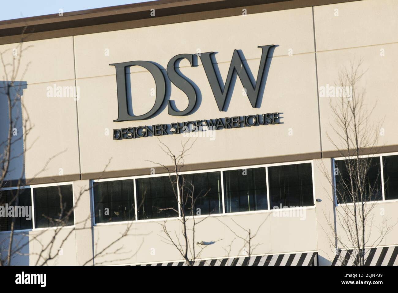 A logo sign outside of a Designer Shoe Warehouse (DSW) retail store ...