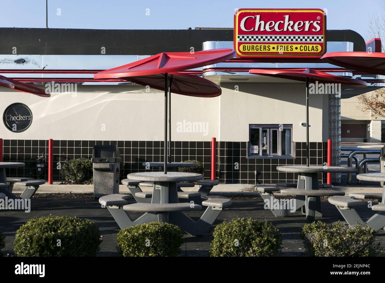A logo sign outside of a Checkers fast food restaurant location in ...