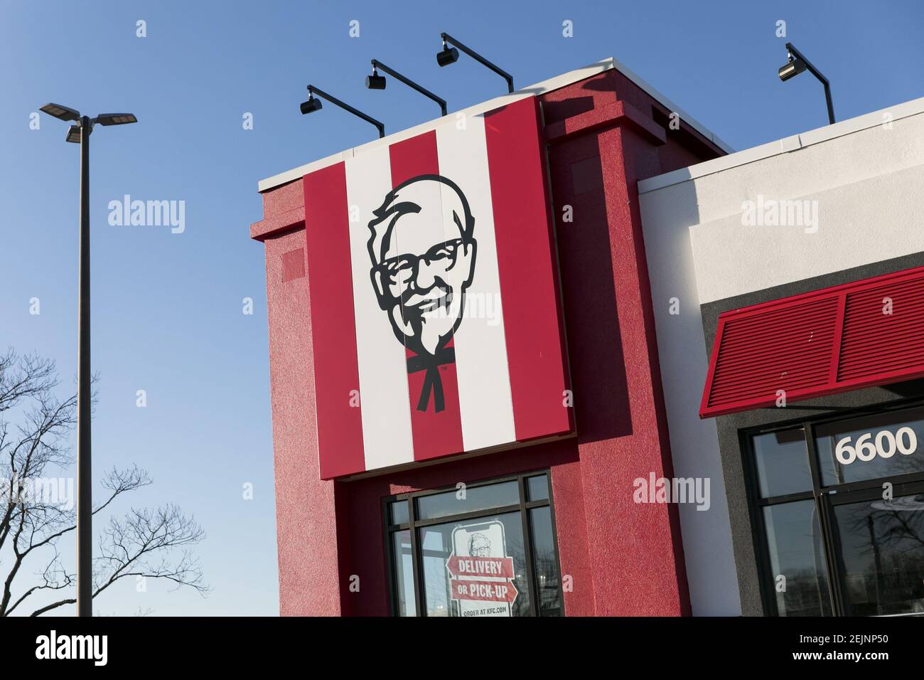 A logo sign outside of a Kentucky Fried Chicken (KFC) fast food ...