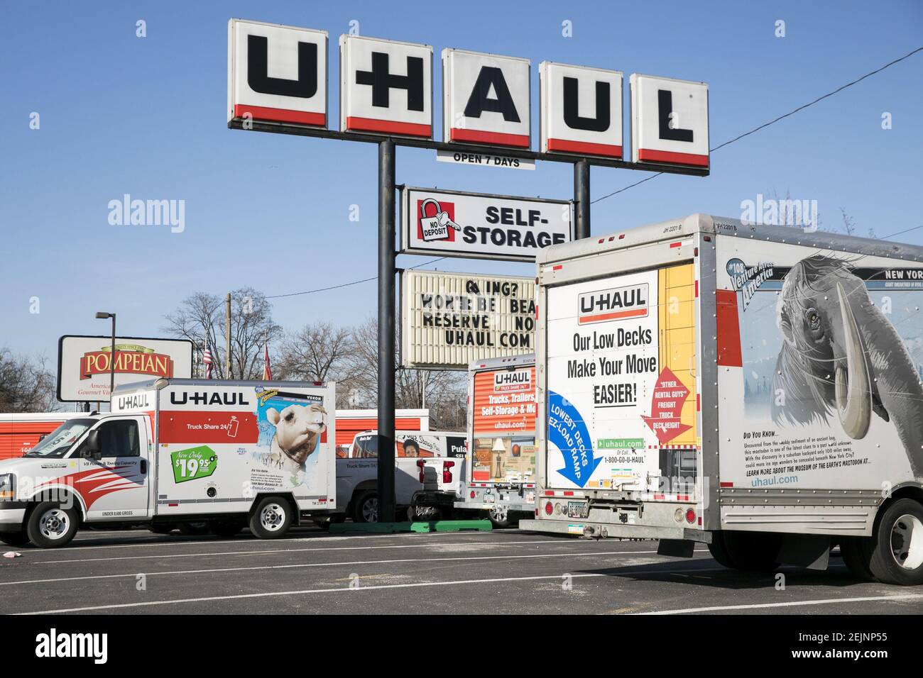 A logo sign and moving trucks outside of a U-Haul location in Baltimore ...