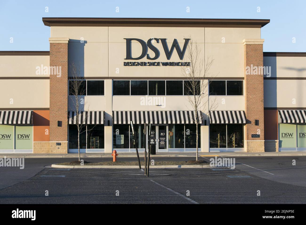 A logo sign outside of a Designer Shoe Warehouse (DSW) retail store ...