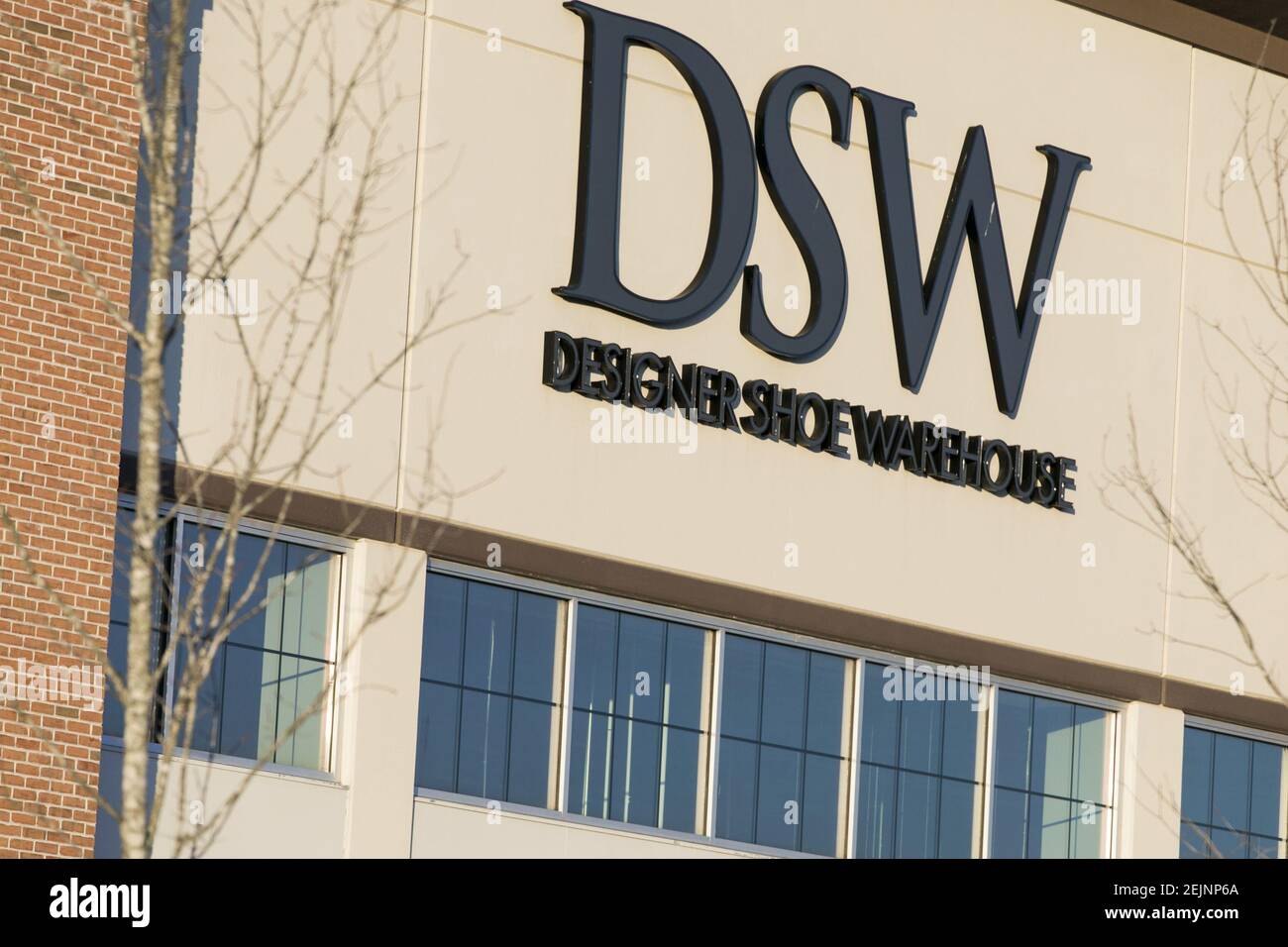 A logo sign outside of a Designer Shoe Warehouse (DSW) retail store ...