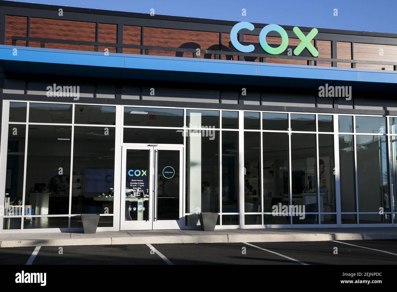 A logo sign outside of a Cox Communications retail store location in ...
