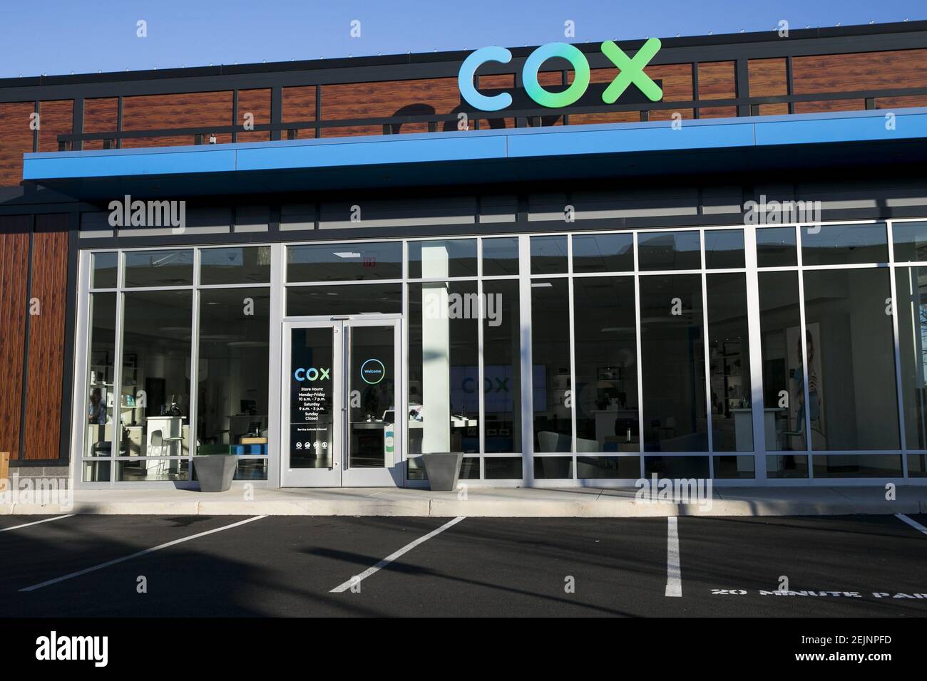 A logo sign outside of a Cox Communications retail store location in ...