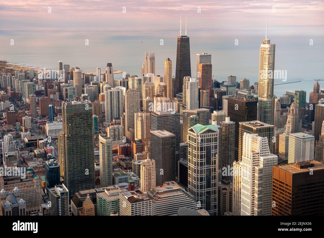 Aerial view of downtown Chicago buildings and Lake Michigan at dusk ...