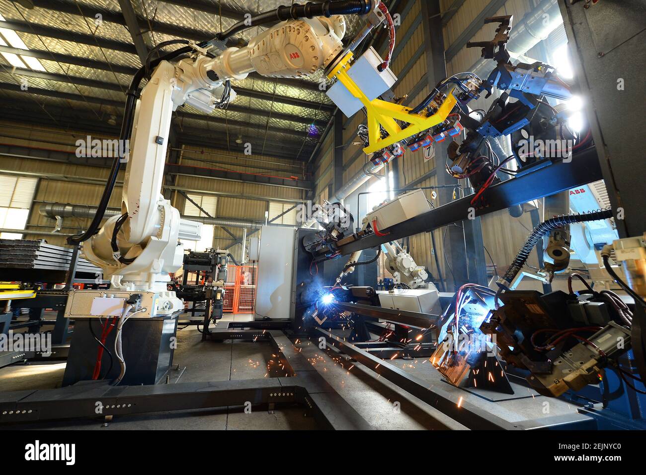 Robot arms weld steel beams at a plant in Taicang City, east China's ...