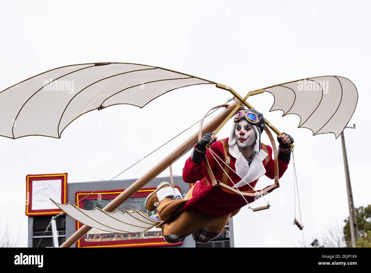 A man dressed as the Joker character performs during the parade ...