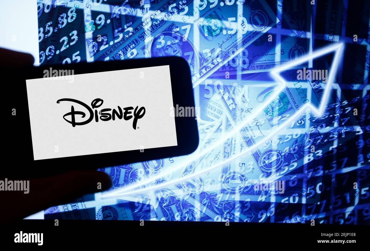 The logo of Disney is seen on a screen of a smartphone next to an ...