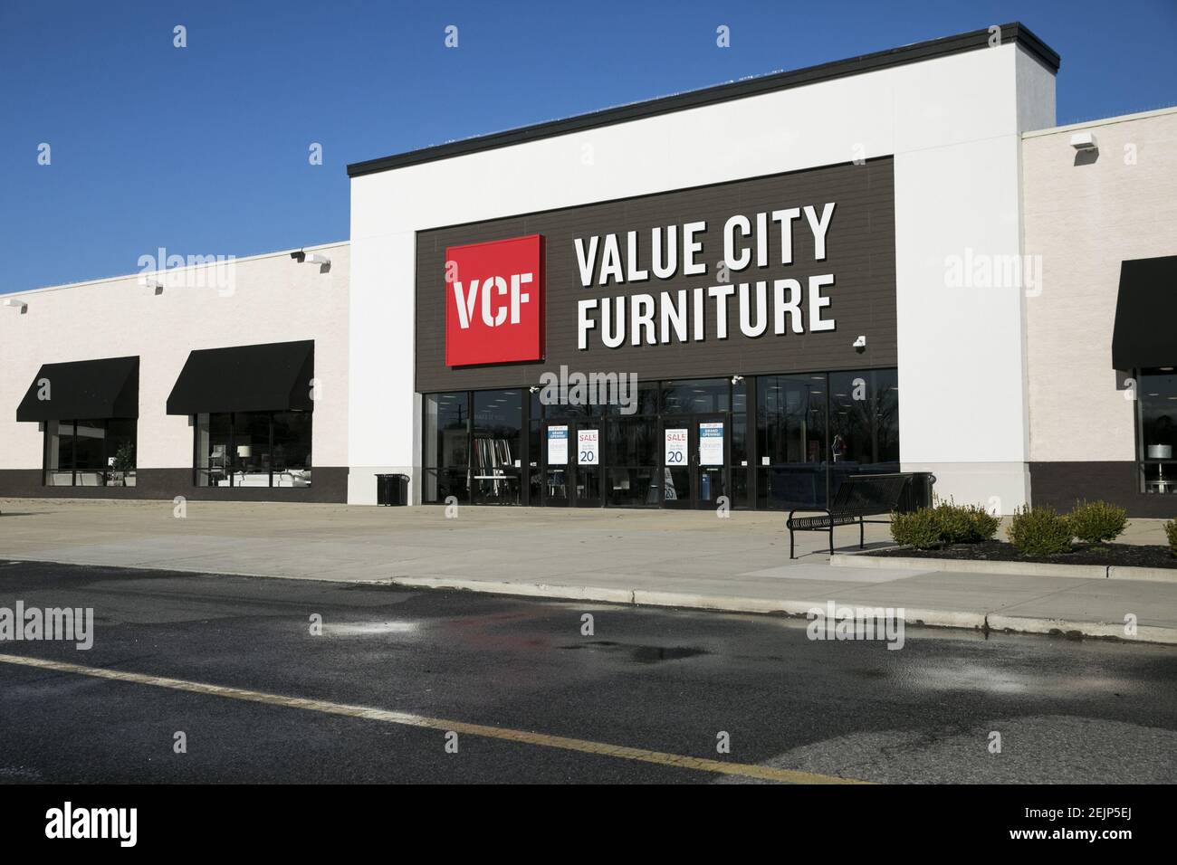 A logo sign outside of a Value City Furniture (VCF) retail store ...
