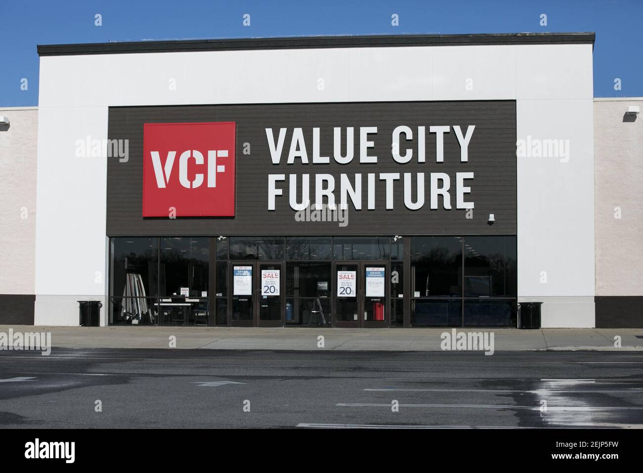 A logo sign outside of a Value City Furniture (VCF) retail store ...