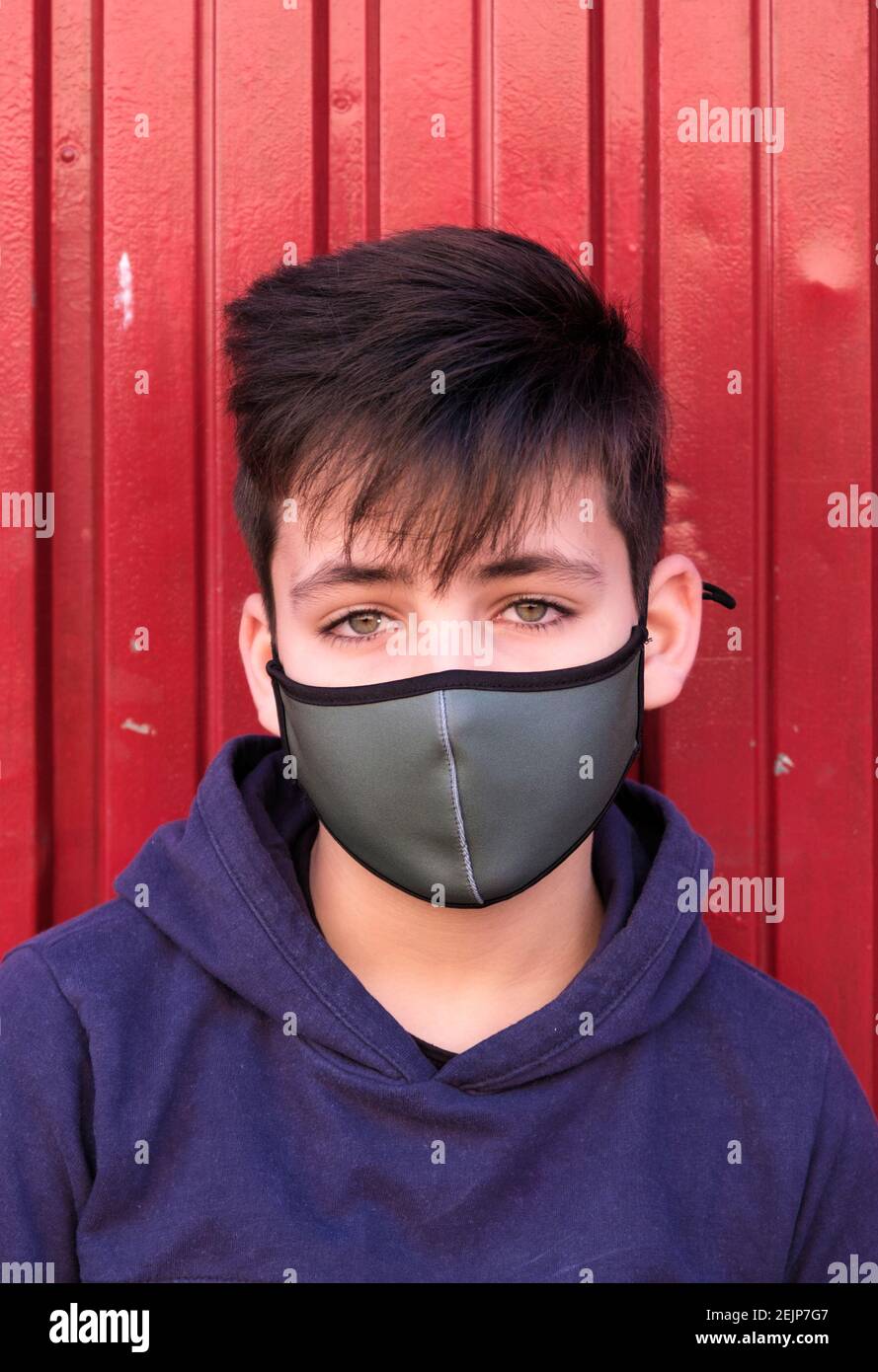 Green eyes boy wearing a green face mask Stock Photo - Alamy