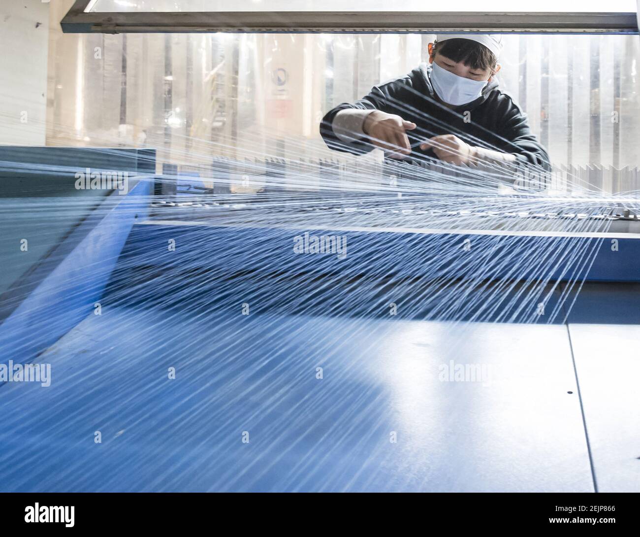 A Chinese worker labors at a textile factory in Chengdong Town, Hai'an ...