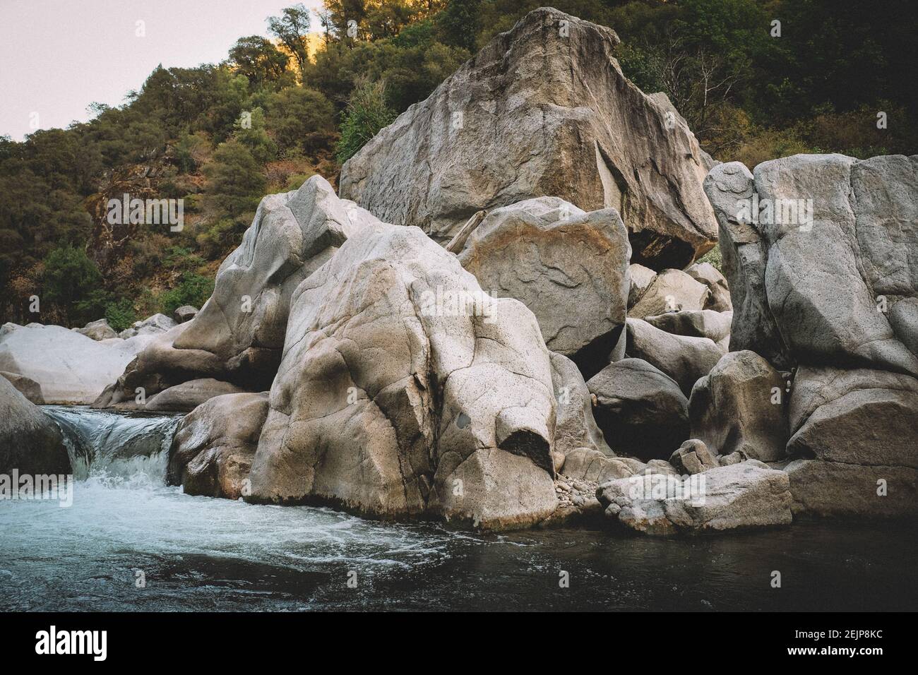 Bubbles from a Small Waterfall pool next to large granite boulders ...