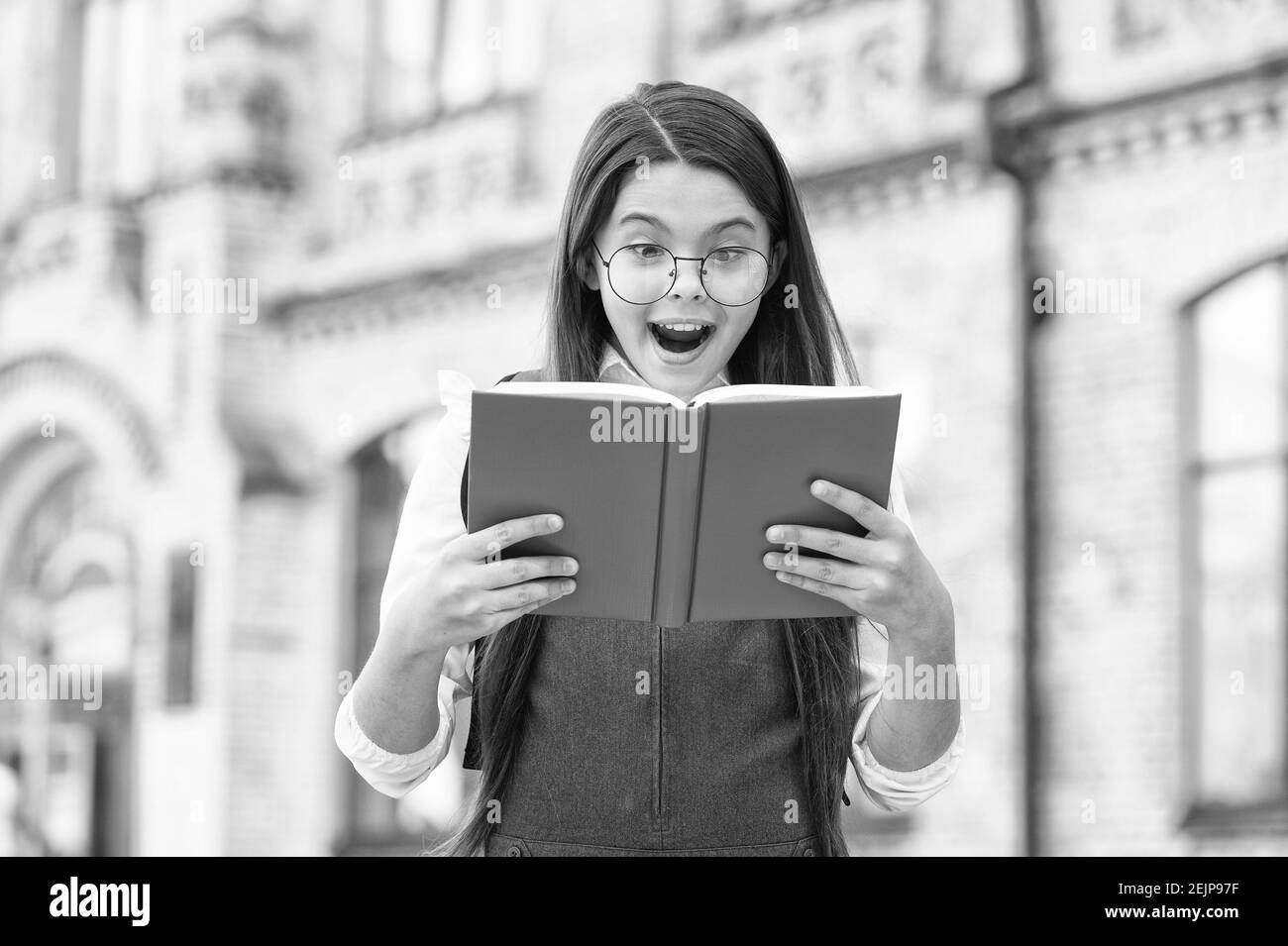 Take a look, read a book. Happy child read book outdoors. School ...