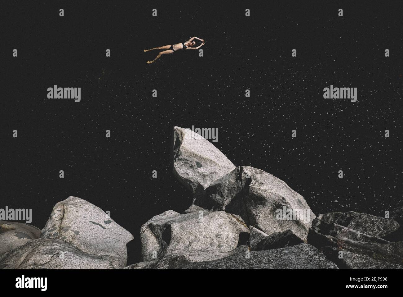 Woman Floats in a Dark Pool of Water That Looks like Space Stock Photo ...