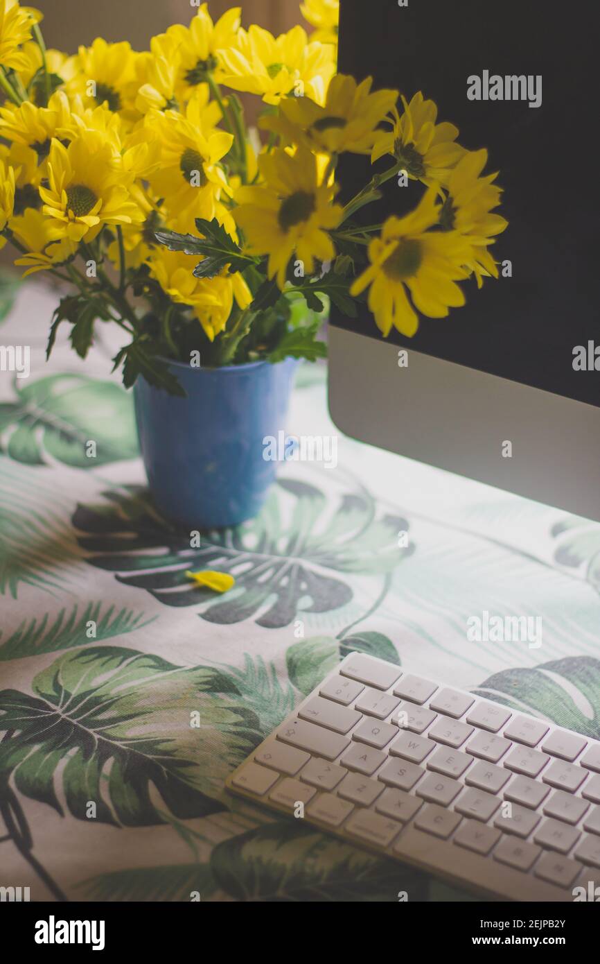 yellow flowers winged from a desktop computer Stock Photo - Alamy