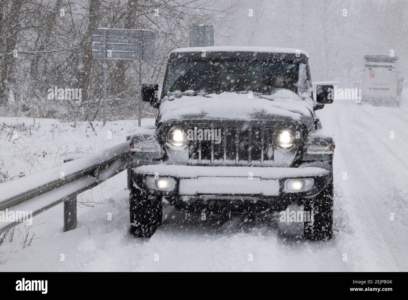 off-road vehicle in the middle of snowfall Stock Photo - Alamy
