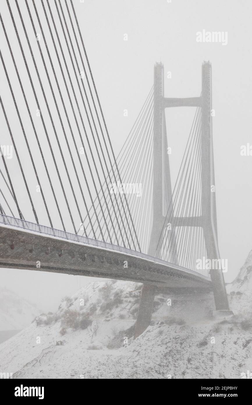 suspension bridge during a snow storm Stock Photo - Alamy