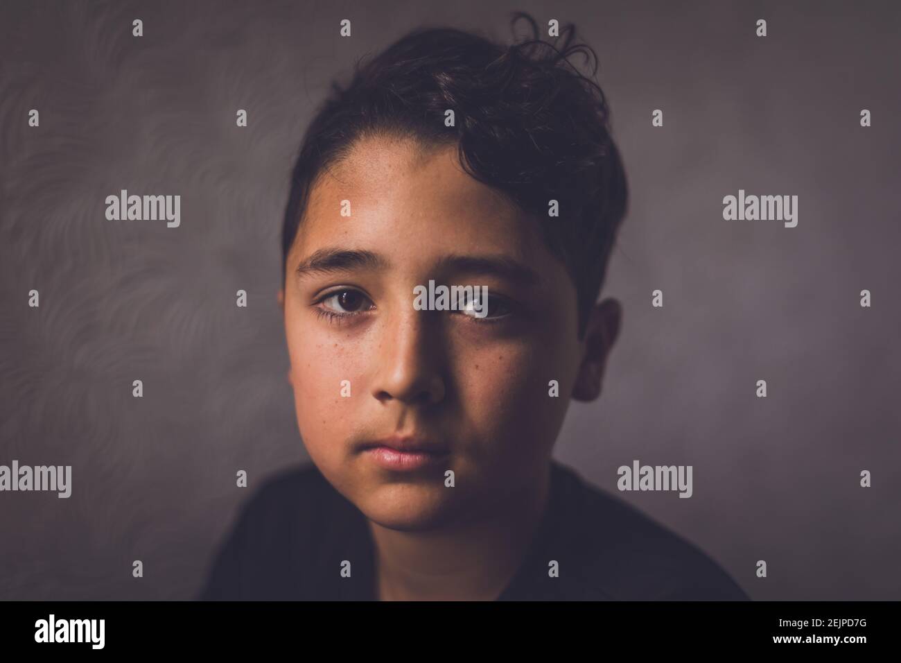 Simple portrait of a boy looking serious Stock Photo - Alamy
